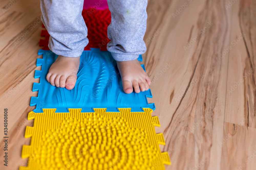 Orthopedic foot mat for child gymnastic. Small children with a flat ...