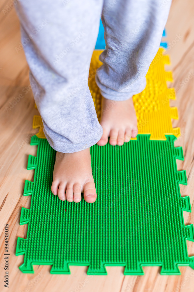 Orthopedic foot mat for child gymnastic. Small children with a flat ...