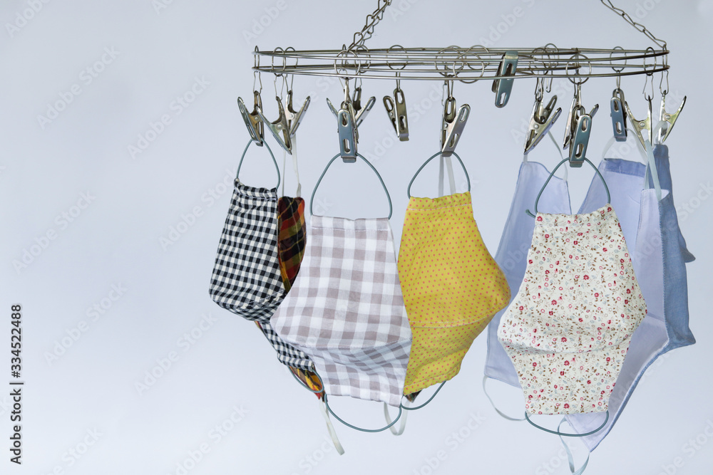 handmade clothes face masks hanging on clothes hanger after washed ...