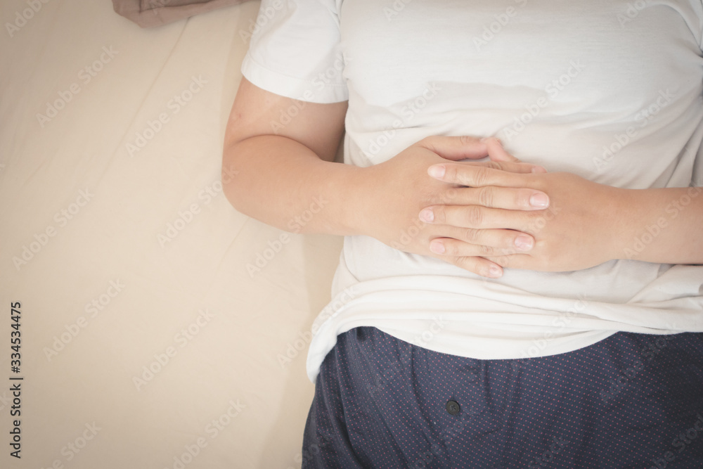 Asian women use their hands to grasp the stomach, showing severe ...