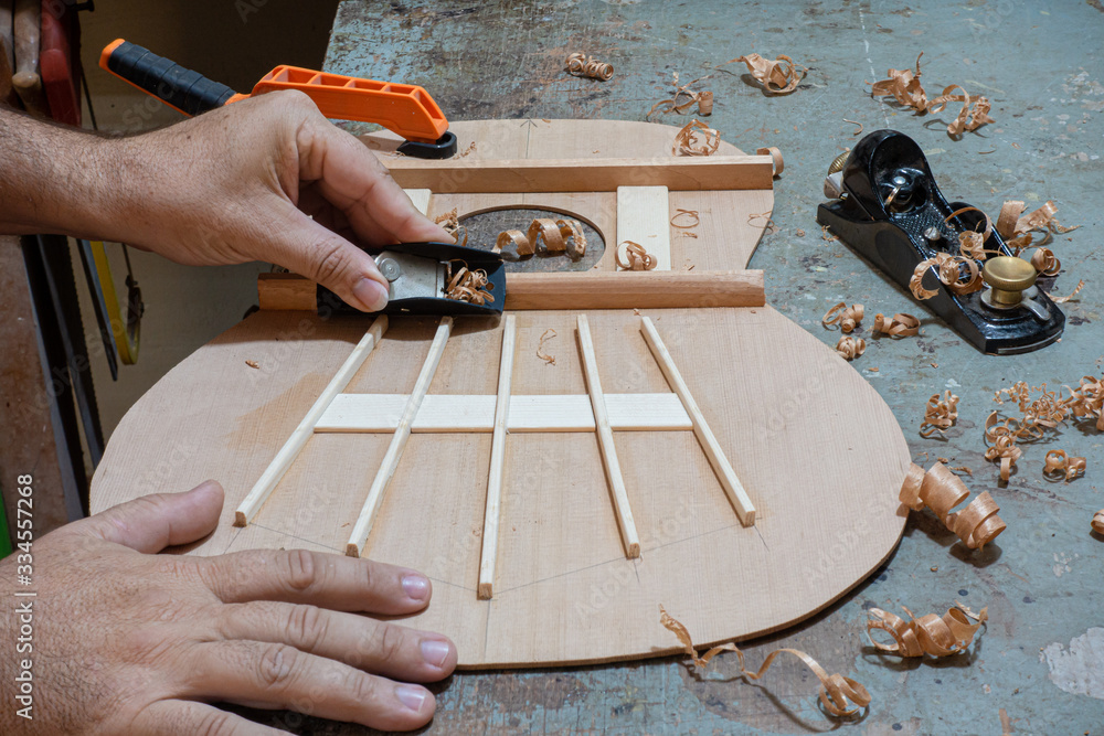 Luthier workbench with tools and a top of an acoustic guitar under ...