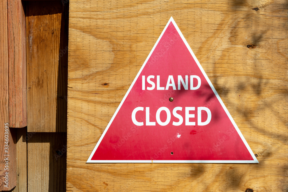 Red Triangle Warning Sign reads "Island Closed" after announcement of ...