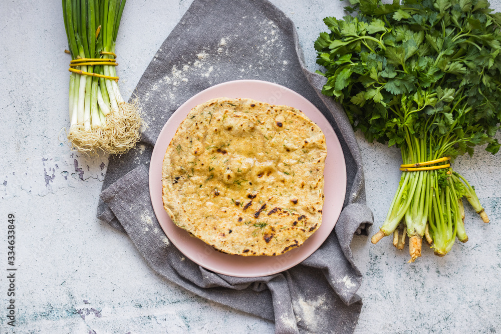 Plain flatbread stuffed with green herbs. Indian traditional chapati ...