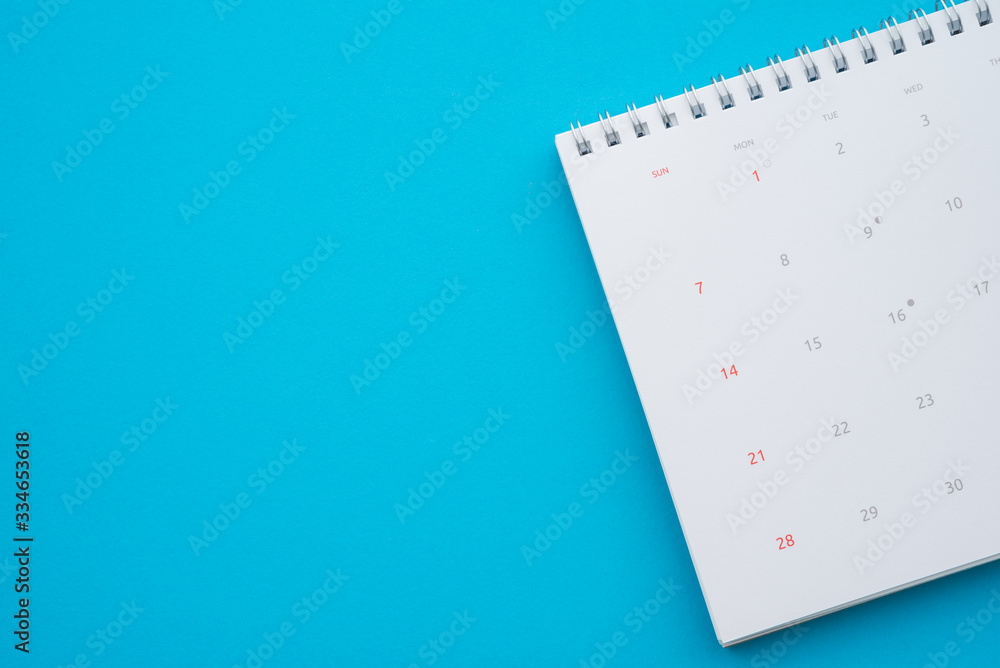 Flat lay of white empty clean calendar on blue background with copy ...