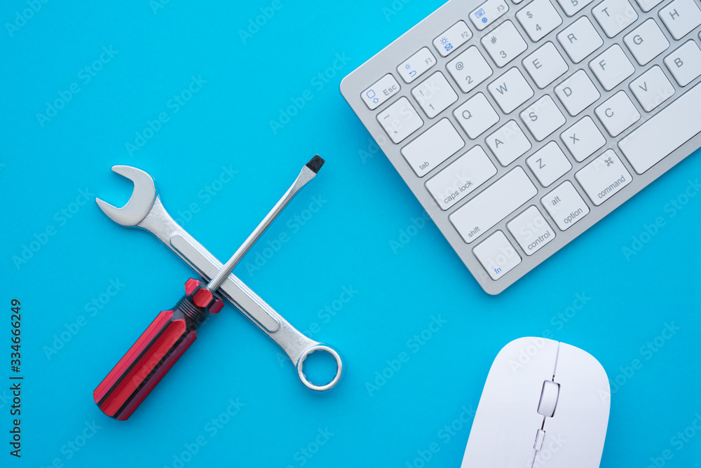Flat lay of combination spanner or wrench, screwdriver, keyboard ...