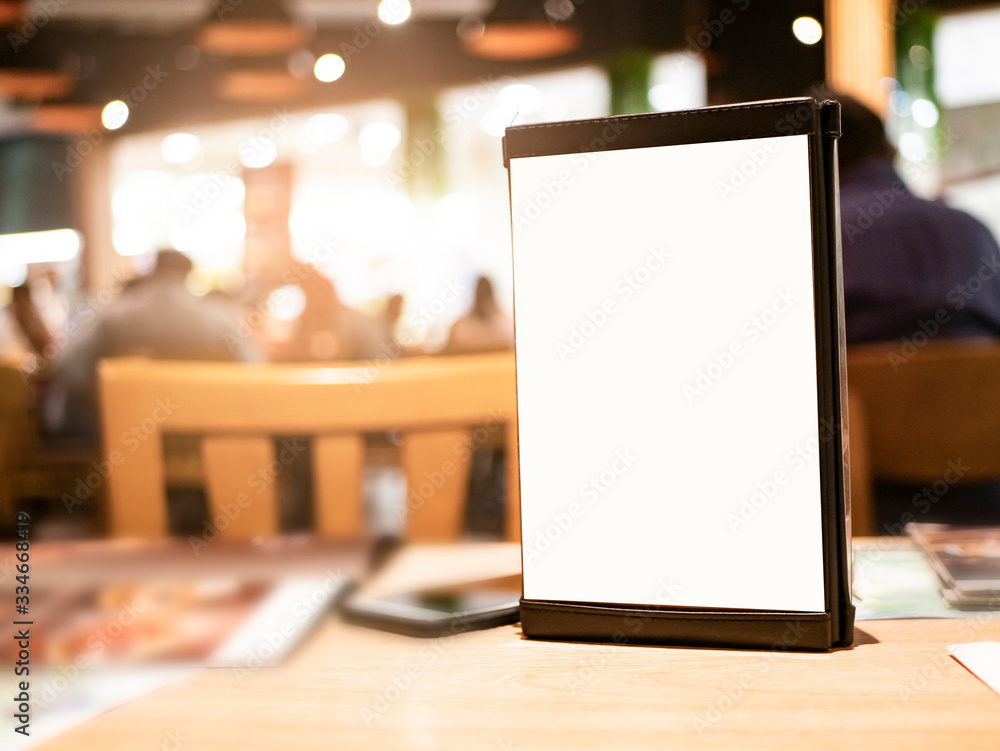mockup of a food menu list stand on wooden table inside restaurant with ...