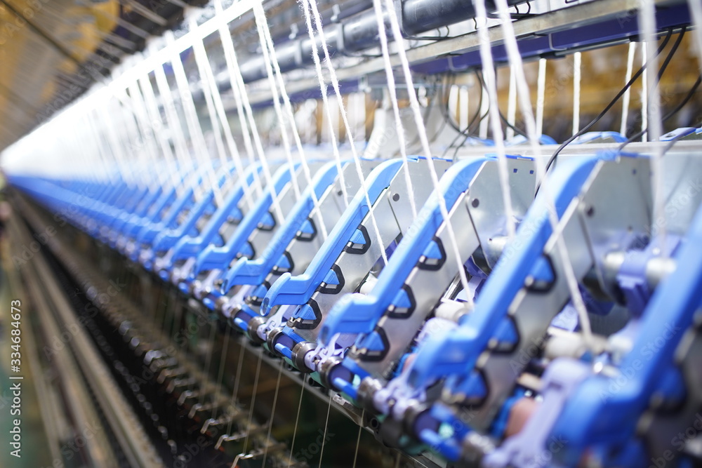 inside a textile factory, detailed image of yarn production and fabric ...