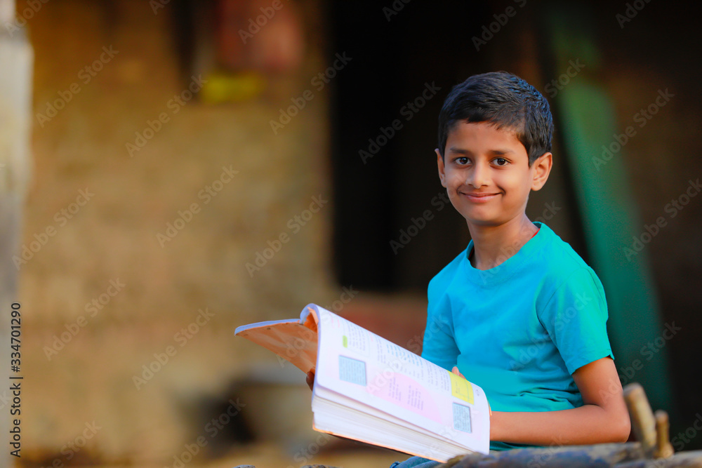 Cute indian child studying at home Stock Photo | Adobe Stock