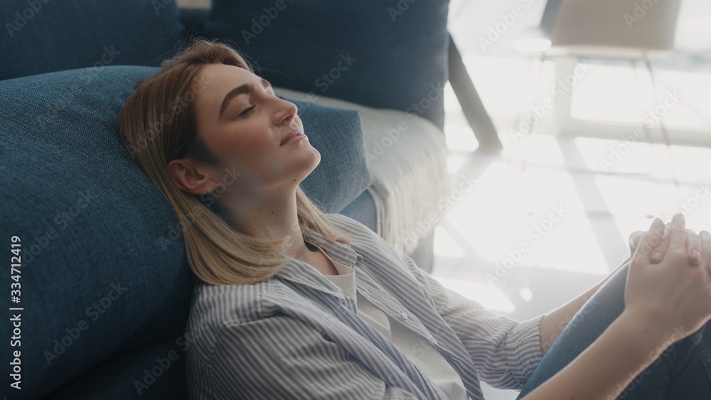 Calm young woman having healthy daytime nap dozing relaxing on sofa ...