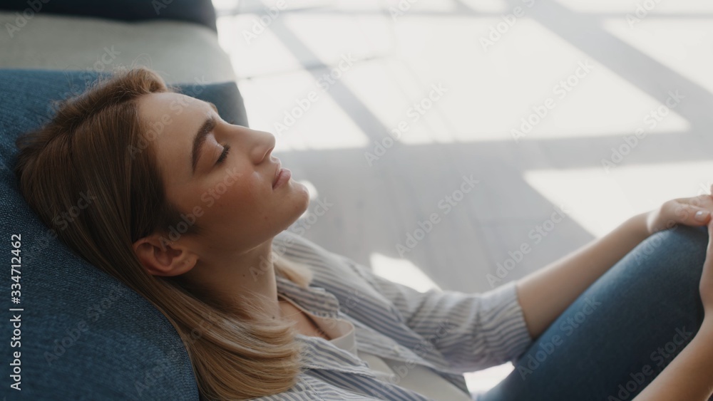 Close up view of calm young woman having healthy daytime nap dozing ...