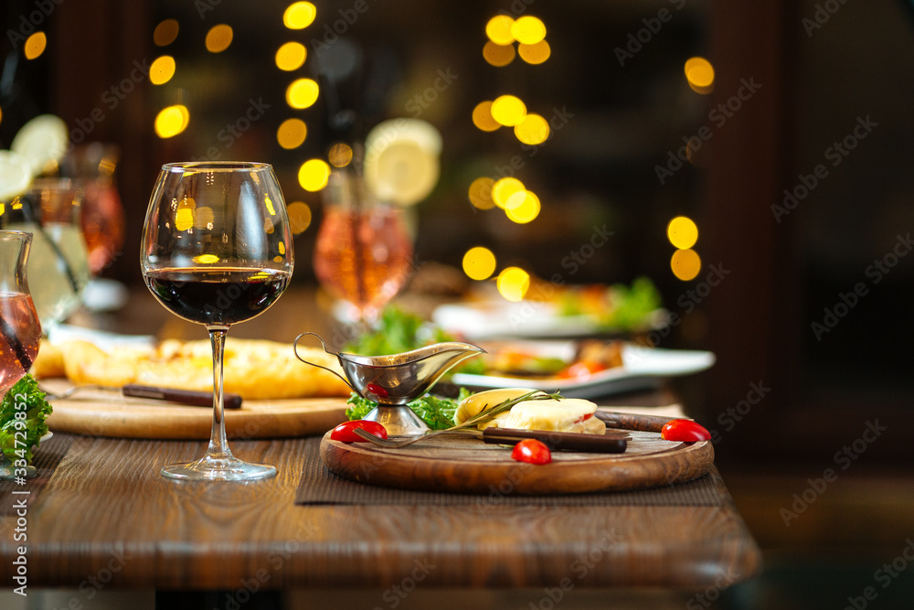 Gala dinner with a glass of red wine, laid table, side view, horizontal ...