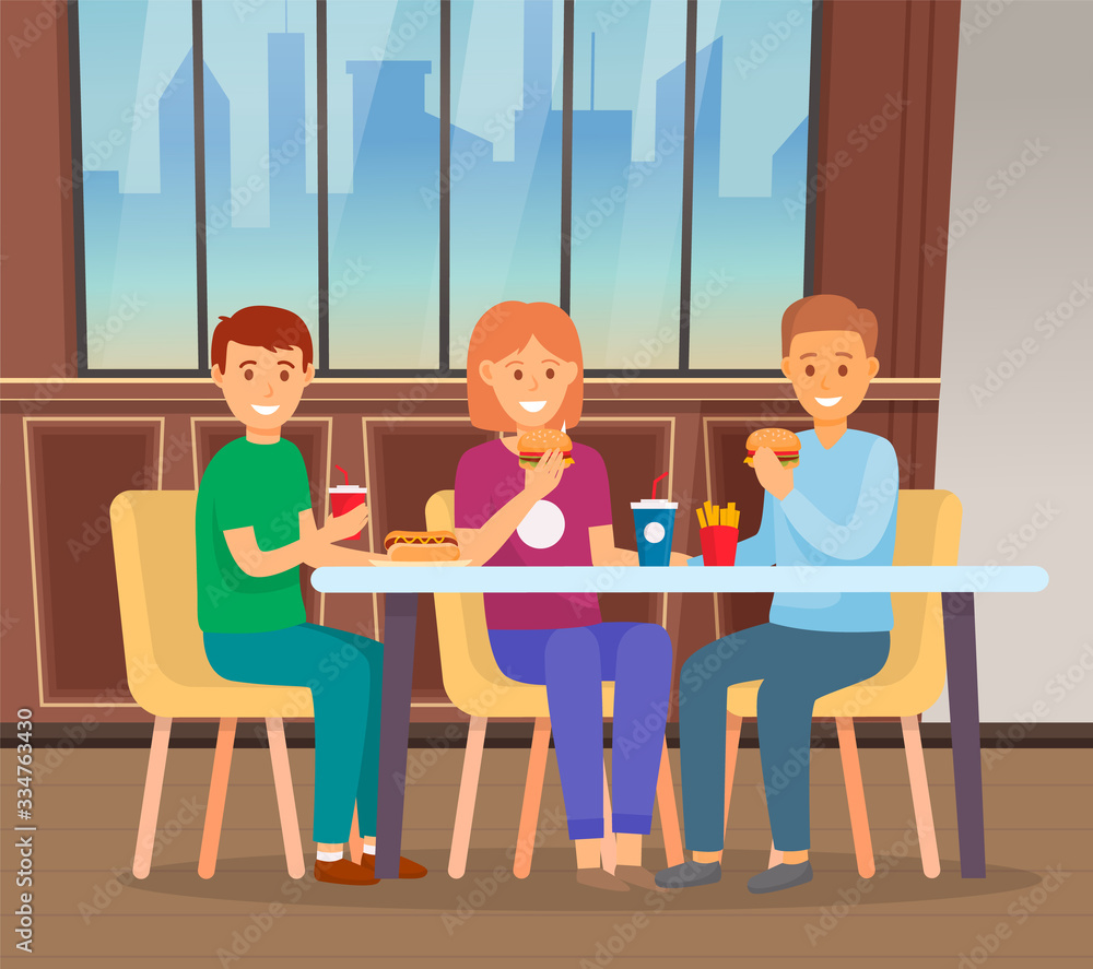 People having lunch together in fast food restaurant. Friends spending ...