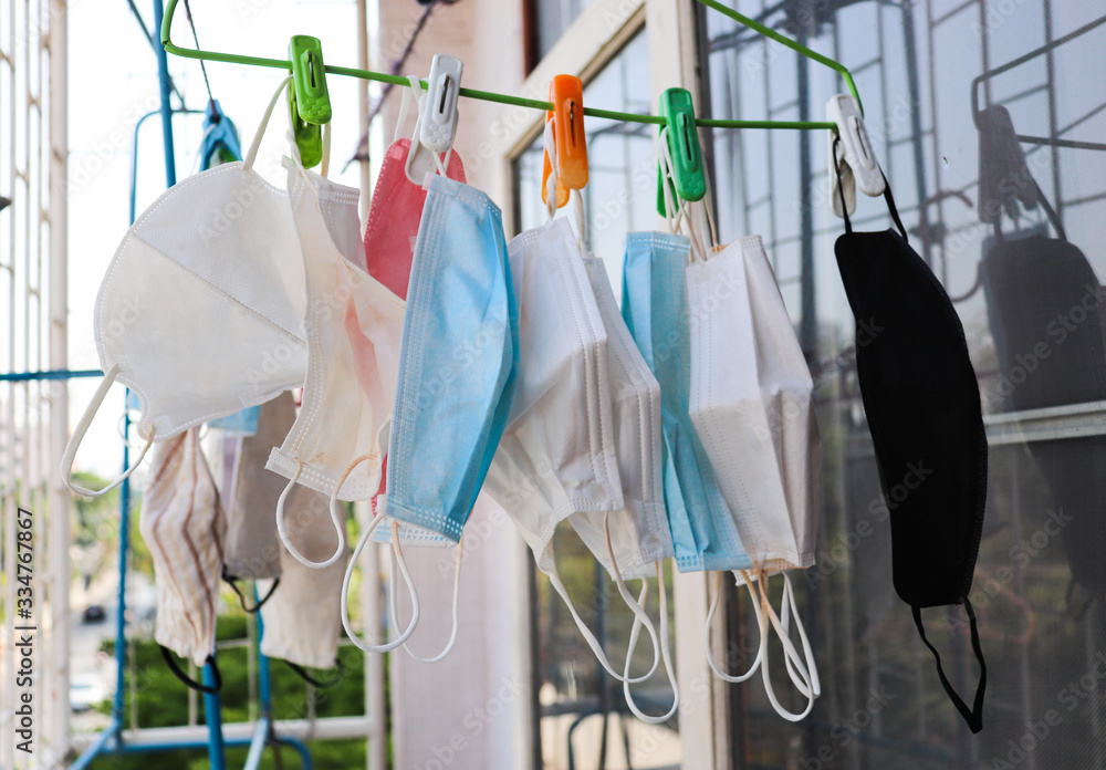 Group of Face Masks Dirty with cosmatic Hanging on the clothes hanger ...