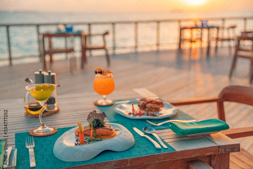 Luxury romantic sunset dinner table setup for couple in ocean view ...