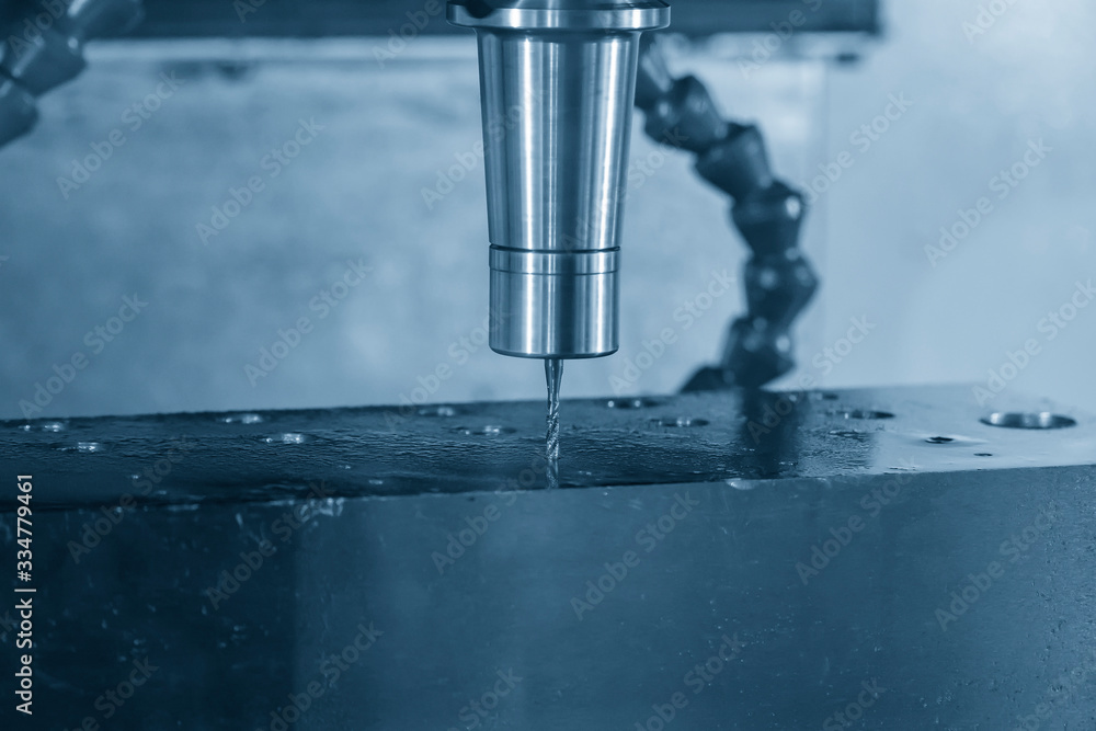 The tapping process on CNC milling machine in the light blue scene. The ...