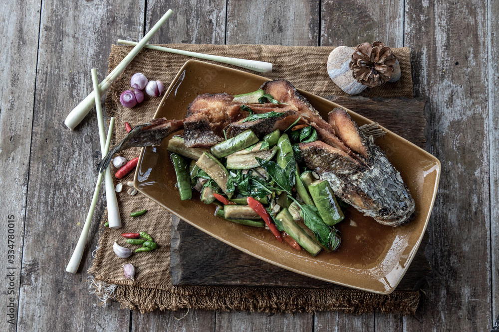 Deep fried whole Snakehead with Spicy stir fry eggplant. Stock Photo ...