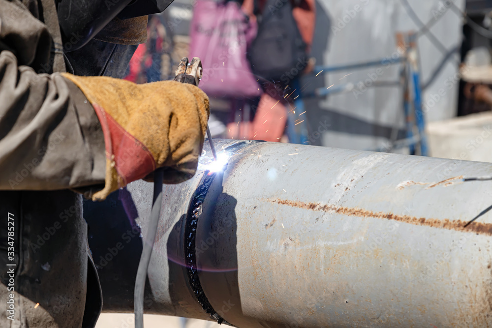 Applying a facing weld using manual arc welding Stock Photo | Adobe Stock