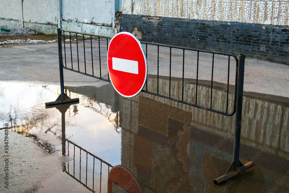 Road sign No entry for vehicular traffic on metal stand in puddle near ...