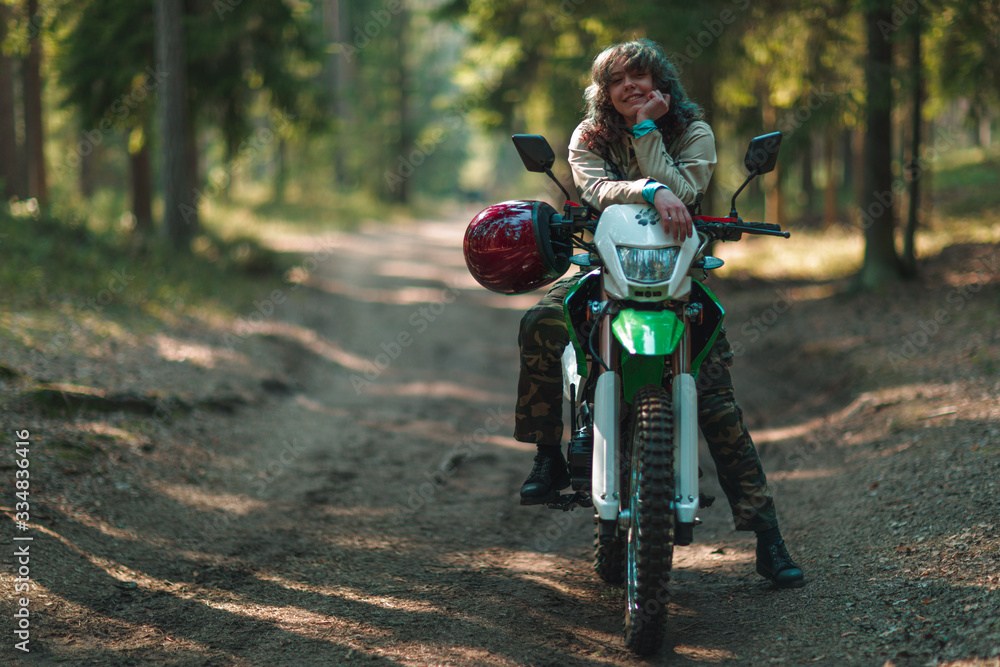 beautiful girl posing on a motorcycle, curly hair, young girl, biker ...