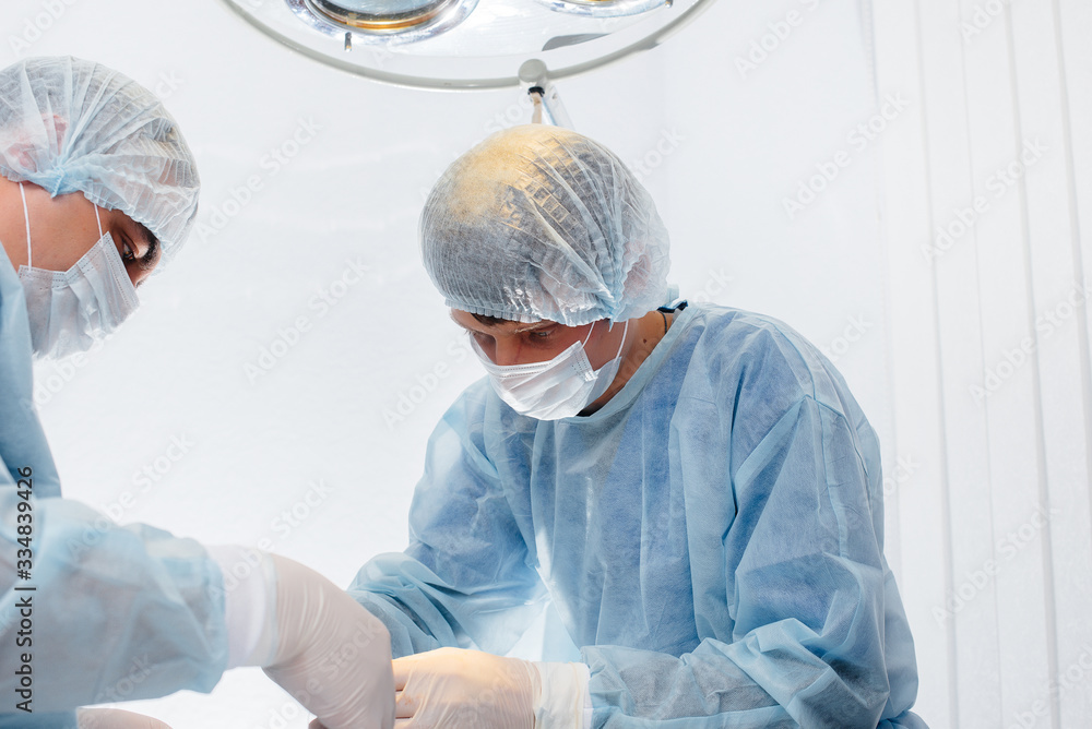 Operation in a modern operating room close-up, emergency rescue and ...