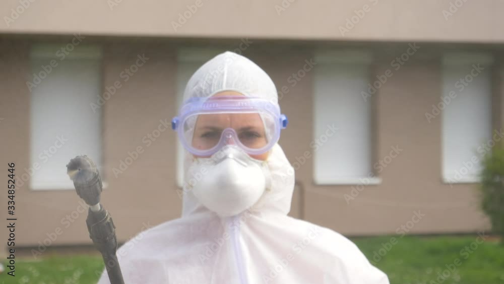 CLOSE UP, PORTRAIT, DOF: Female epidemiologist in protective biohazard ...