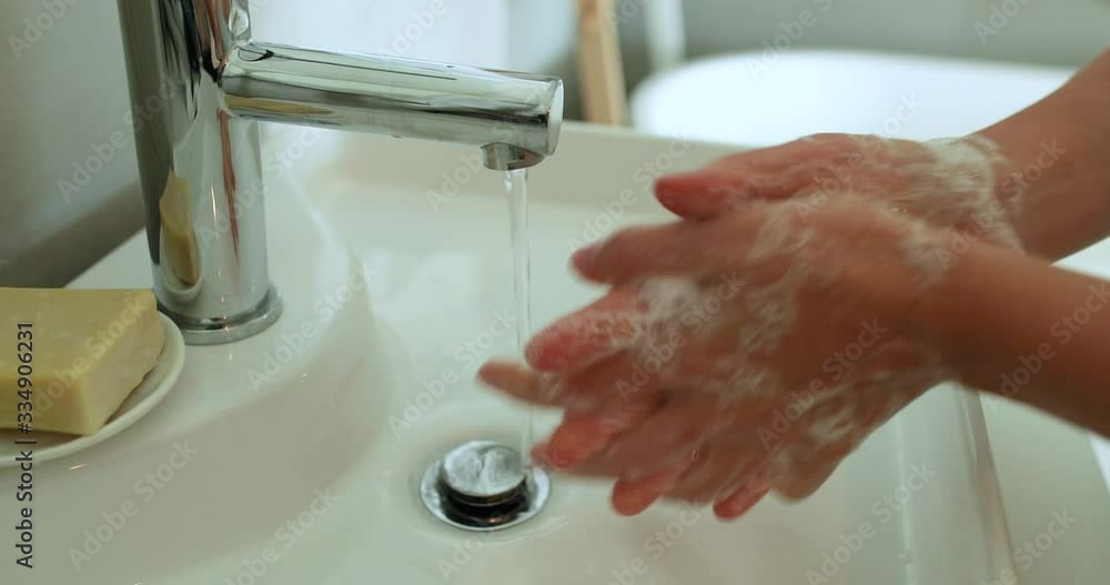 Coronavirus pandemic prevention washing hands rubbing wrist and palms ...