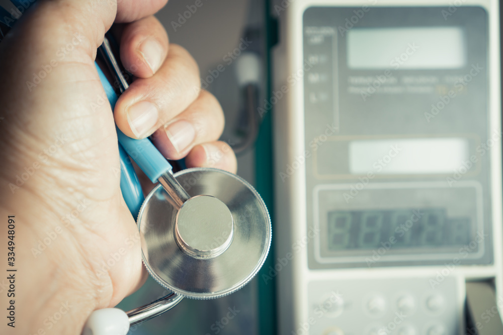 Doctor holding Stethoscope for checking treatment patient with saline ...