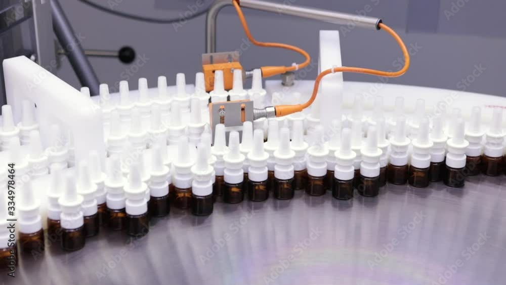 Sterile bottles and ampoules on the dispensing line. Sealed ampoules ...