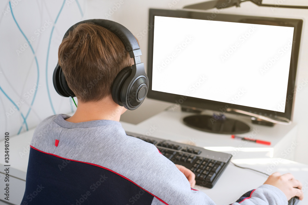teenager boy looking at computer monitor. computer screen mockup. happy ...