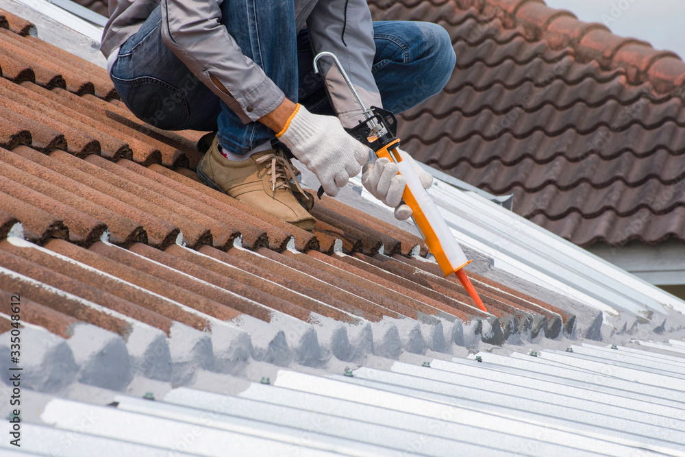 Technician man hand using glue gun with silicone adhesive or manual ...