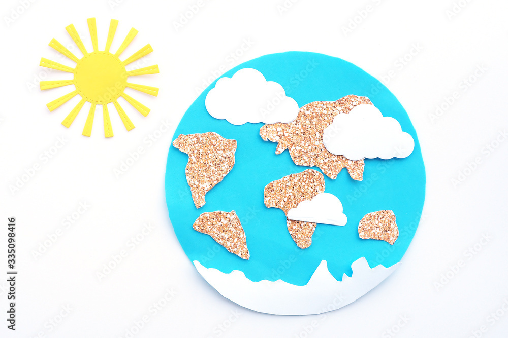 paper application: planet Earth, continents, clouds and the sun on a ...