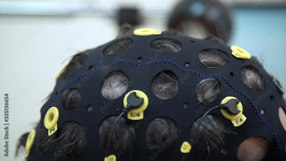 Doctor preparing man for brain scan in hospital. The installation of ...