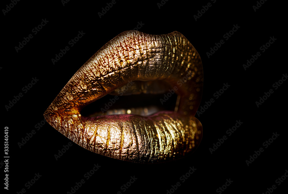 Gold lips. Gold Paint from the lips. Golden lips on beautiful model ...