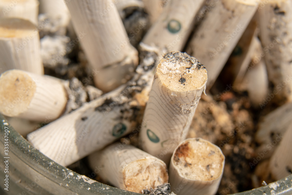 Old and stinky cigarette filters in the dirty jar converted into an ...