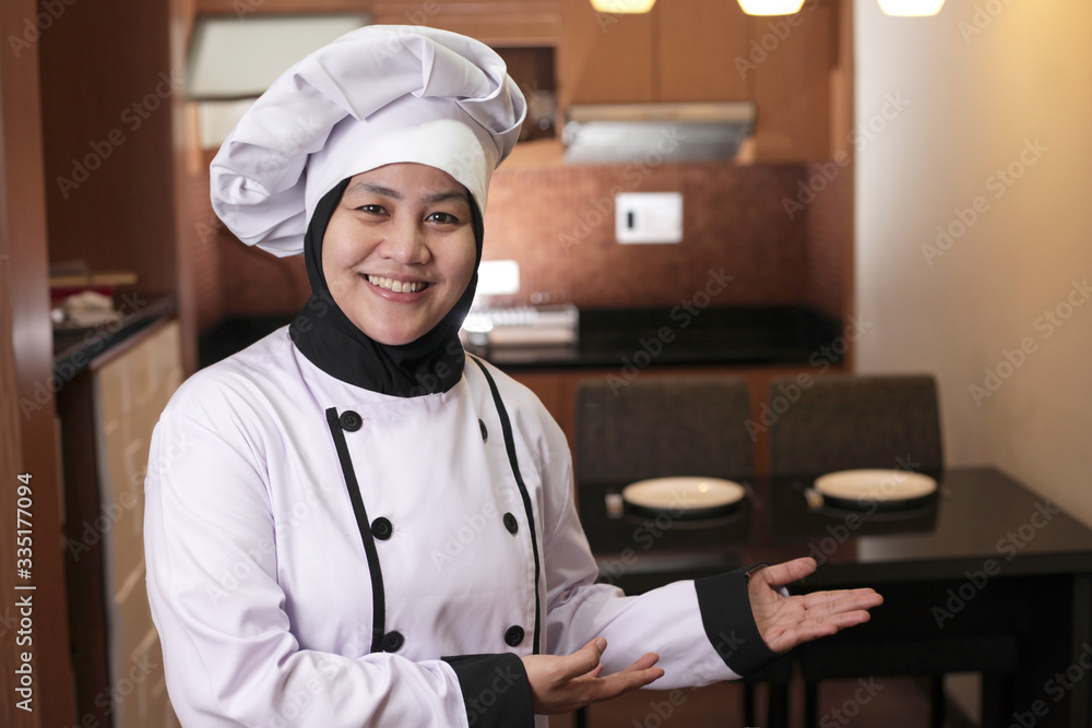 Asian female chef smiling friendly when welcoming customer to her ...