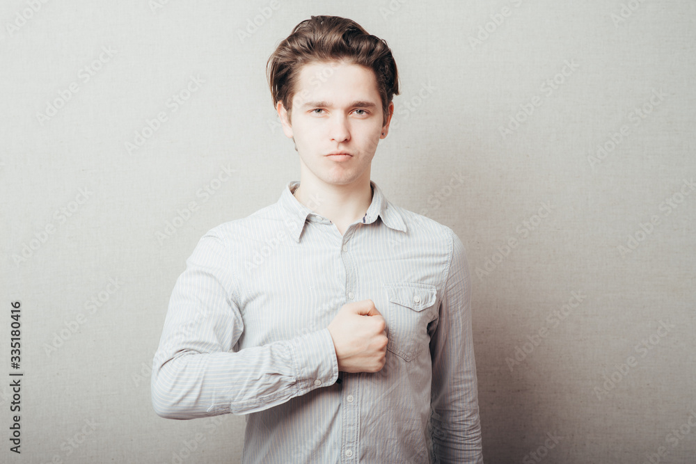 Young handsome man is swearing allegiance with his hand, fist on chest ...