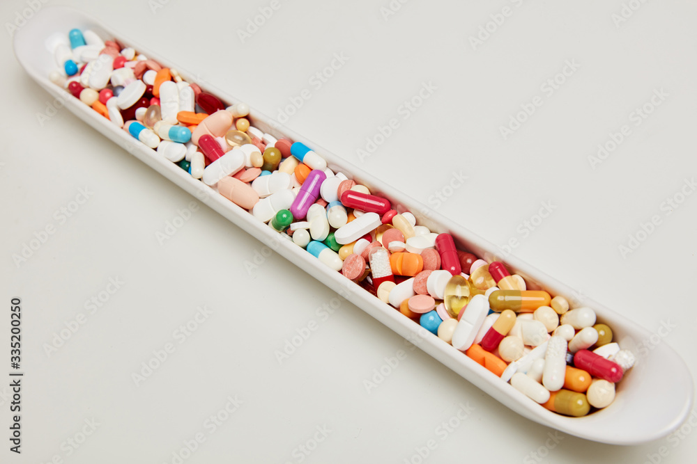 Bowl with a lot of colorful medicines drugs and tablets Stock Photo ...