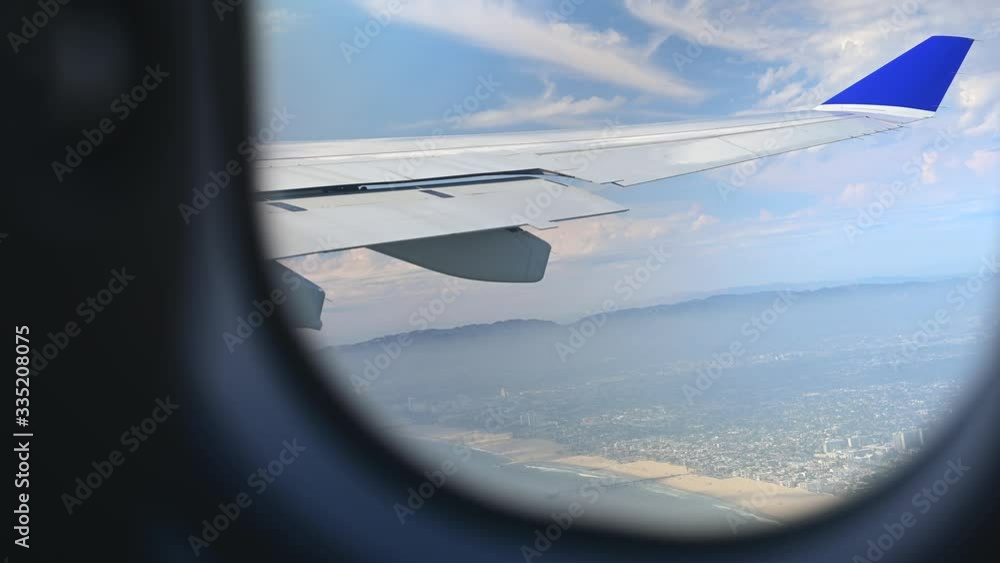 Big passenger airplane taking off from an airport of a big city next to ...