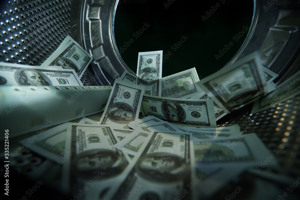 Washing banknotes in machine, money laundering, financial fraud concept ...
