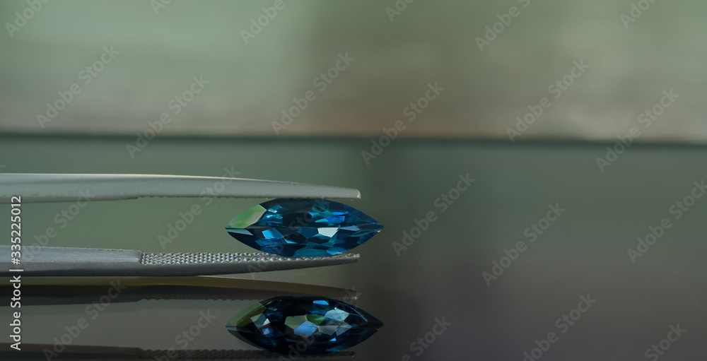 Blue sapphire Gemstone Expensive blue in a tong Stock Photo | Adobe Stock