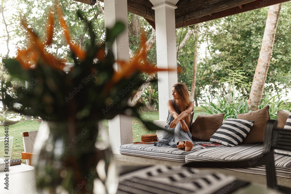 Photo of beautiful girl sitting on veranda and enjoying calm weather ...