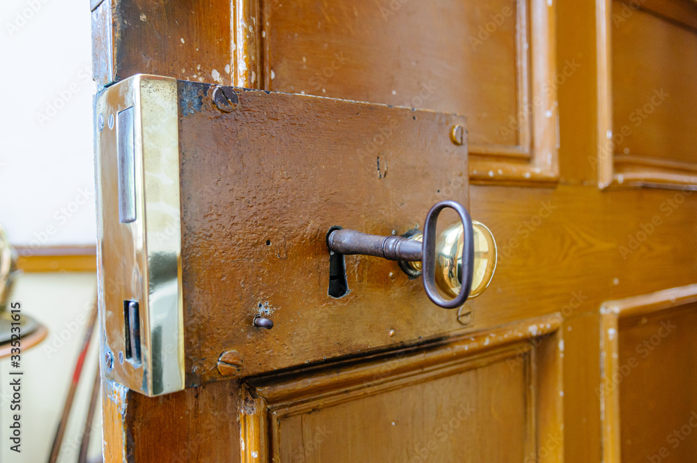 Heavy brass lock on the inside of a door, with a large old-fashioned ...