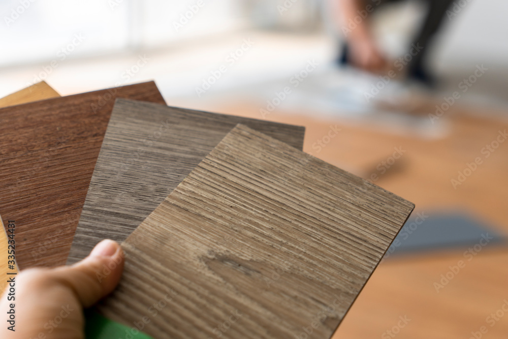 luxury vinyl floor tile collection : stack of vinyl with blurry step of ...