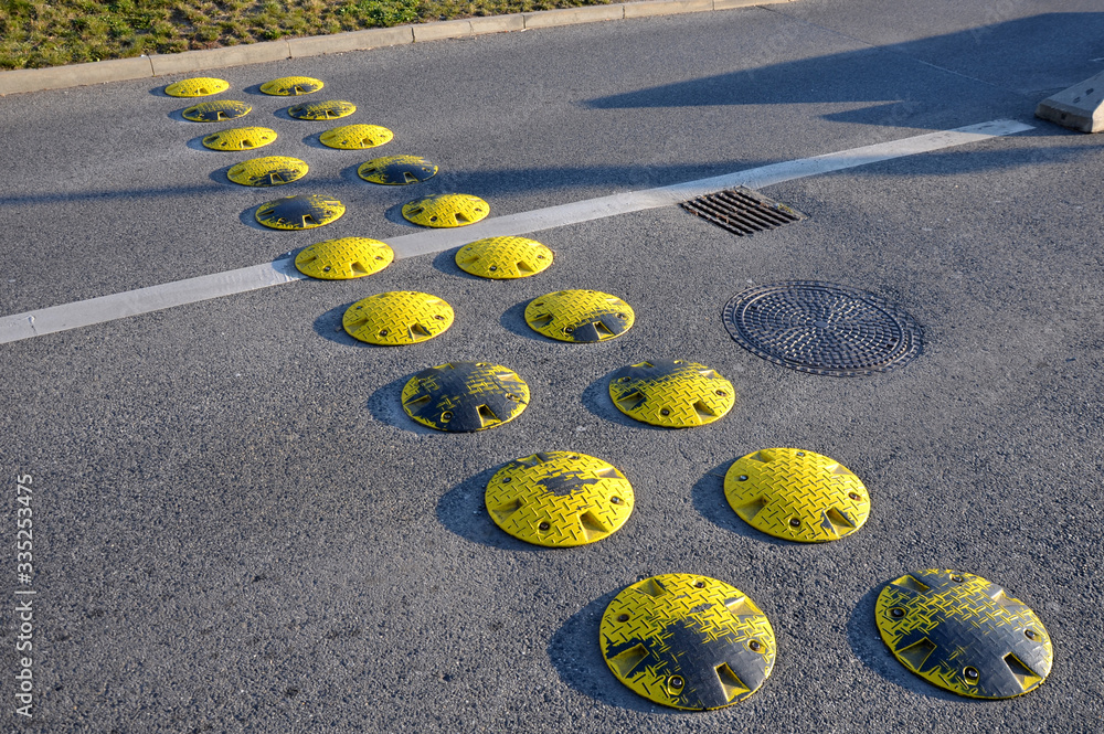traffic element retarder yellow round points in two rows on a road ...