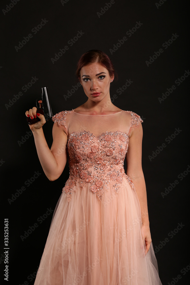 Cute girl in pink dress with Makarov pistol Stock Photo | Adobe Stock