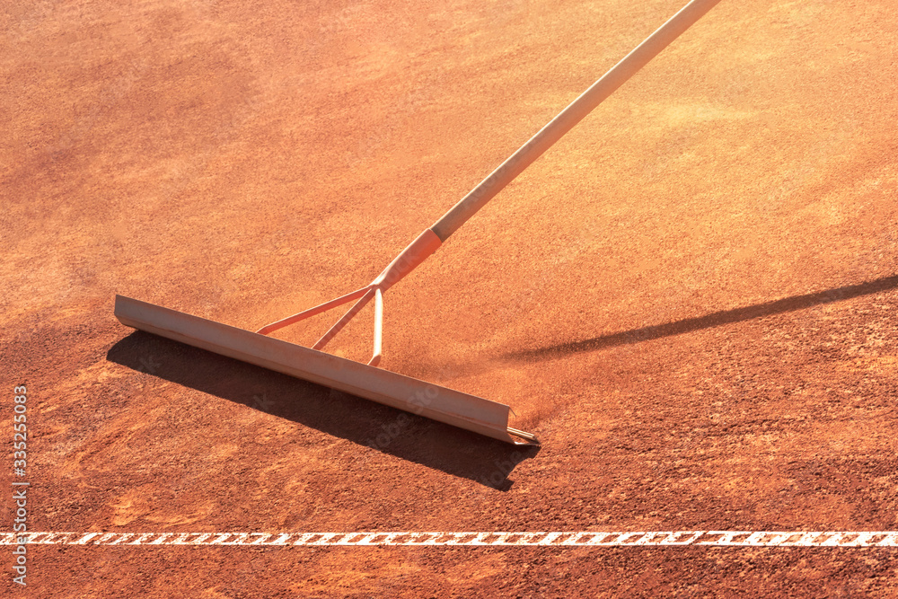 Clay tennis court preparation. A tool for leveling the ground on a ...