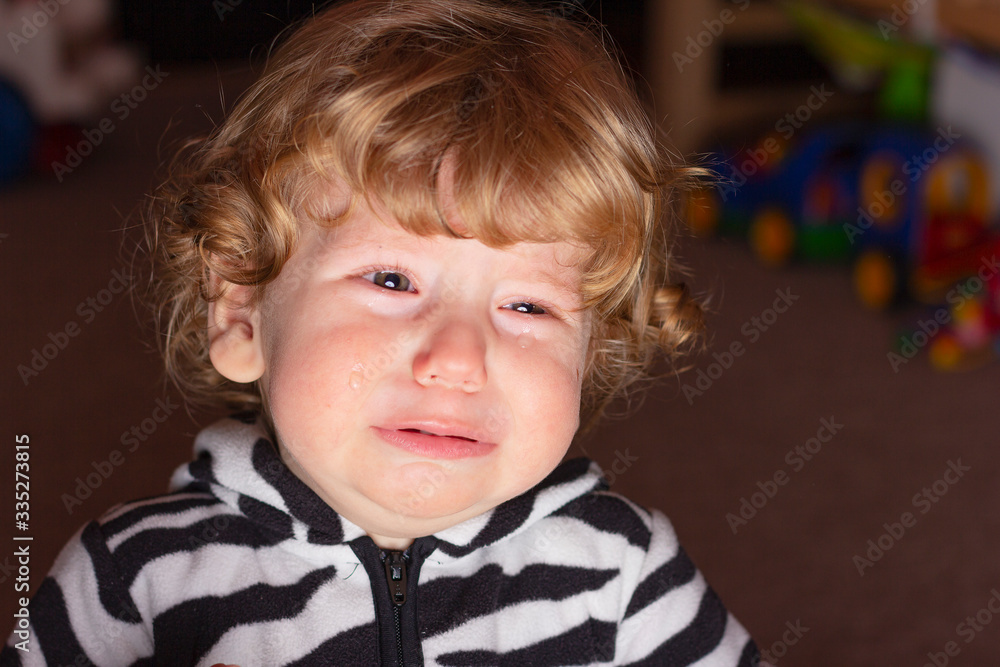 The baby is crying in the dark. Little boy cries before going to bed ...