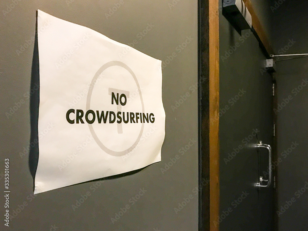 Sign on the wall of a night club stating "No crowd surfing" Stock Photo ...