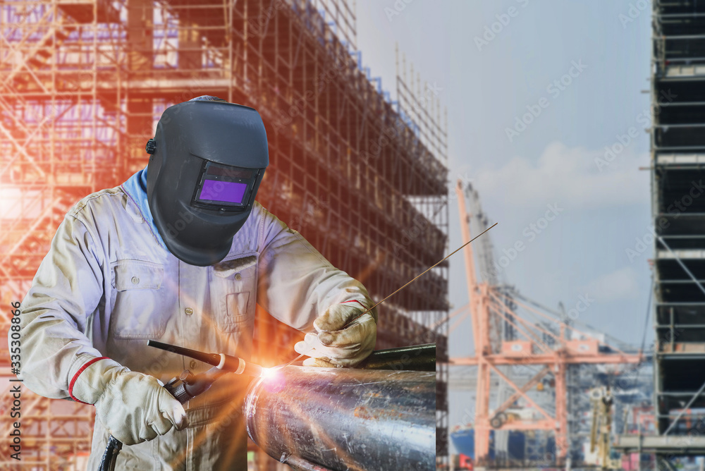 welder is welding construction site wearing equipment protection PPE ...