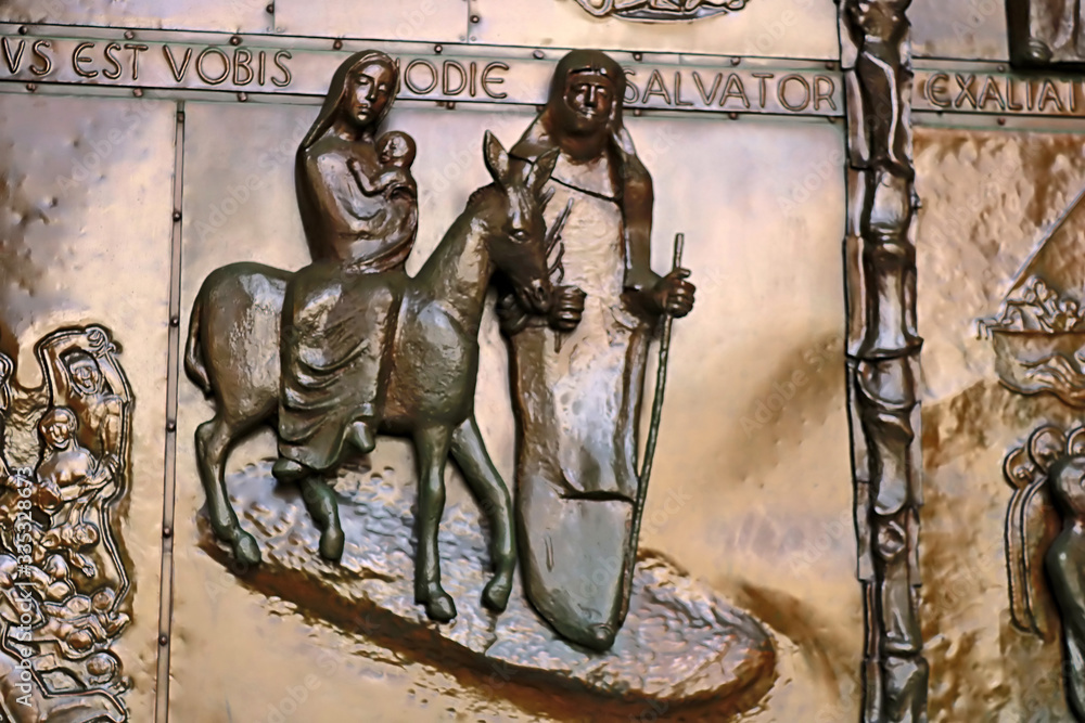 Detail of the wonderful metal door showing Joseph leading a donkey ...